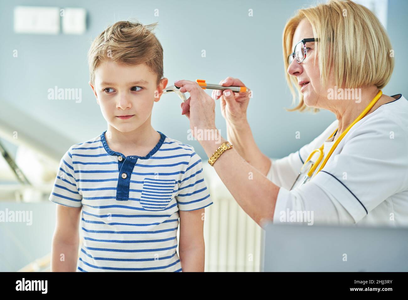 Pediatrician doctor examining little kids in clinic ears check Stock ...