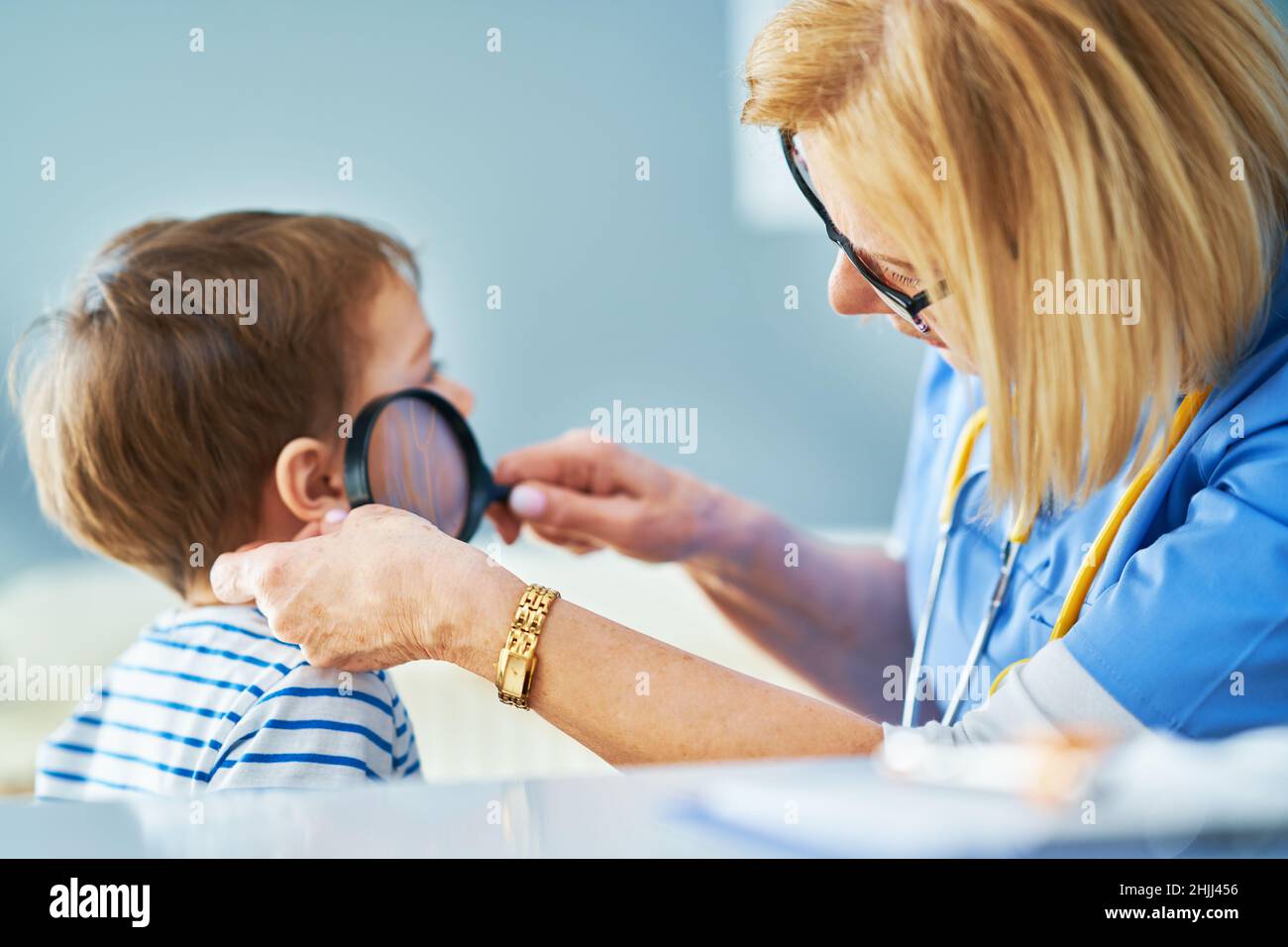 Pediatrician doctor examining little kids in clinic ears check Stock ...