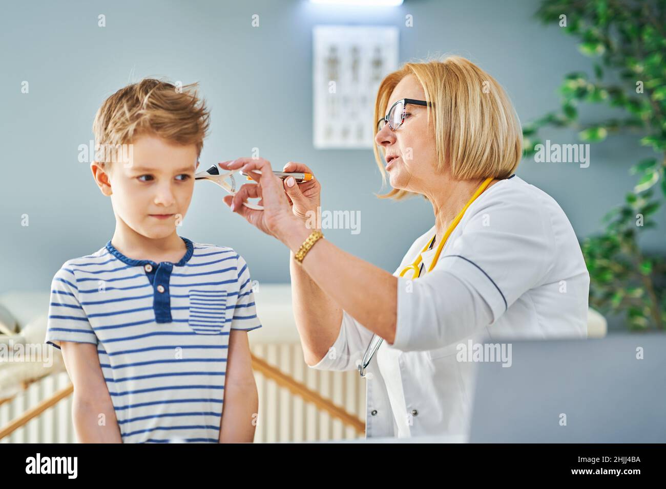 Pediatrician doctor examining little kids in clinic ears check Stock ...