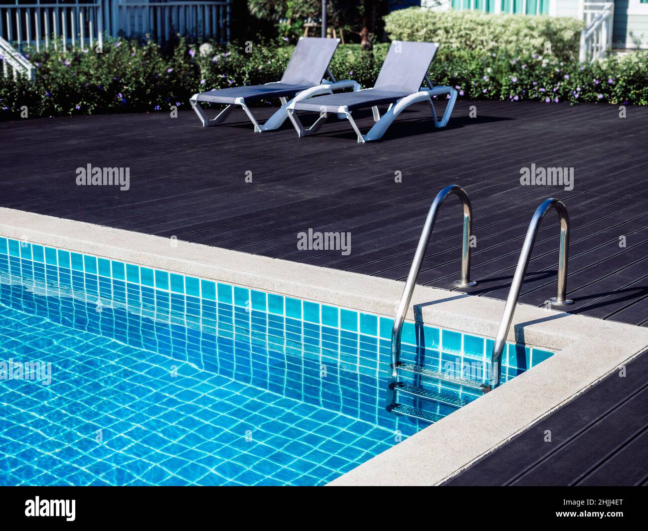 Stone edge frame on the square swimming pool with clean clear water ...