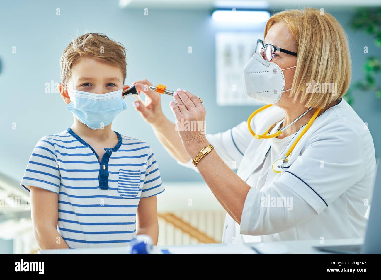 Pediatrician doctor examining little kids in clinic ears check Stock ...