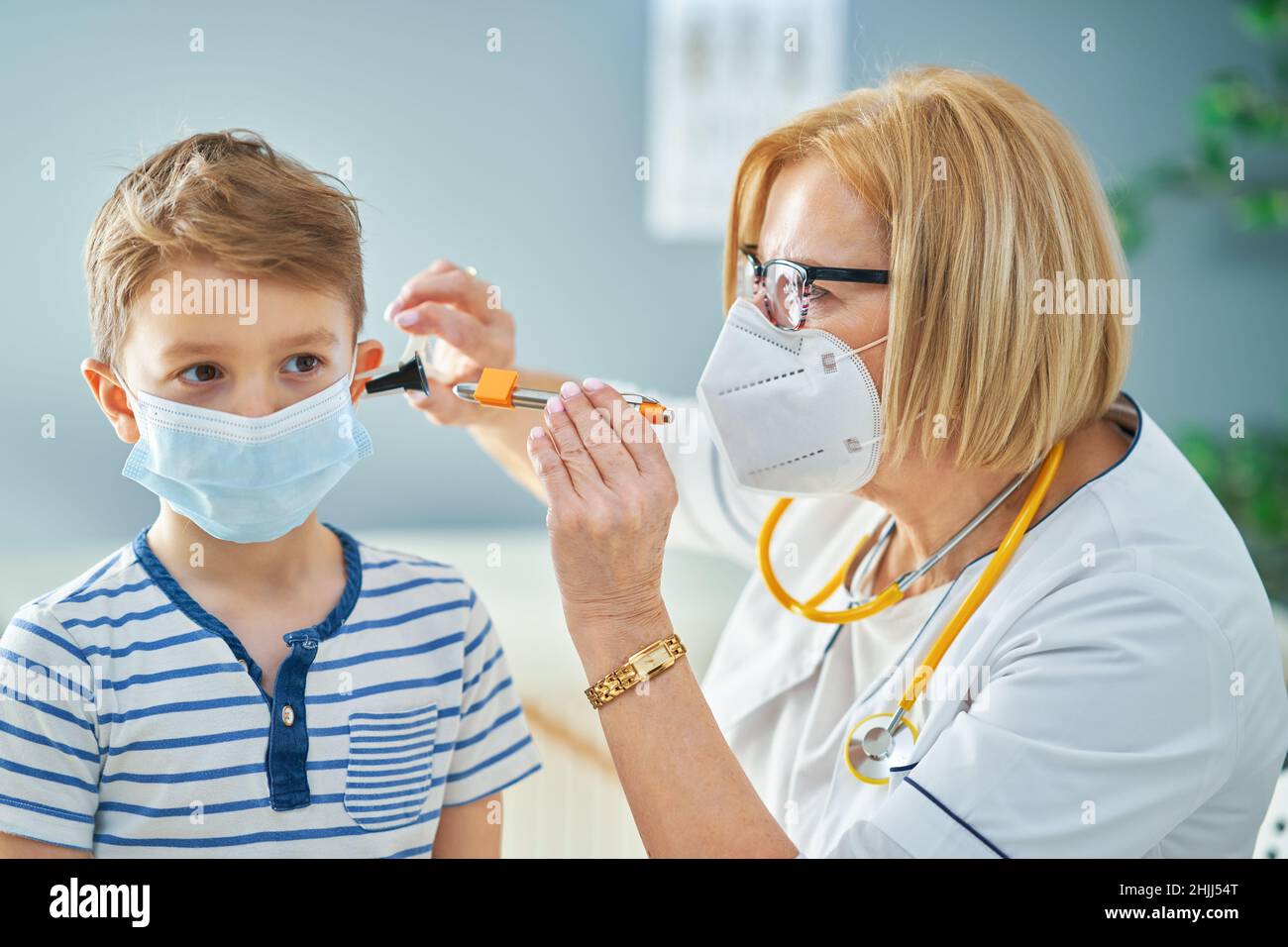 Pediatrician doctor examining little kids in clinic ears check Stock ...