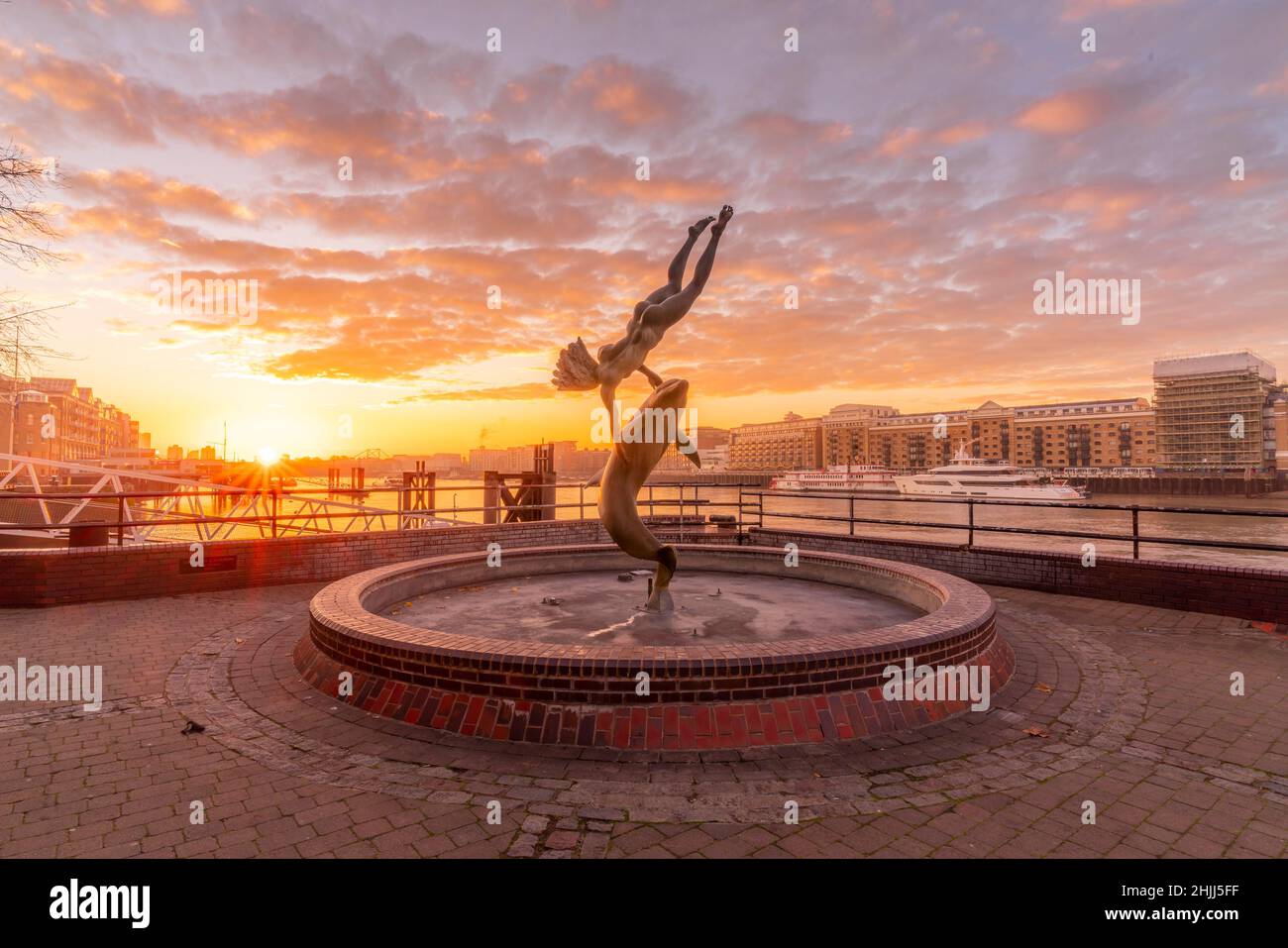 View of Girl with Dolphin statue and River Thames with dramatic sky at ...