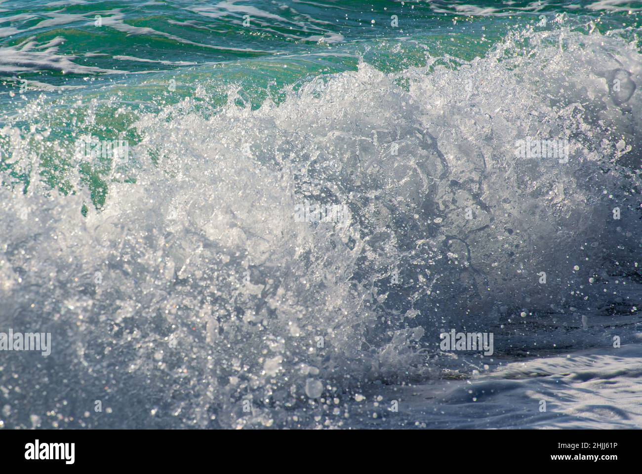 Blue wave breaking on a beach in sea Stock Photo - Alamy