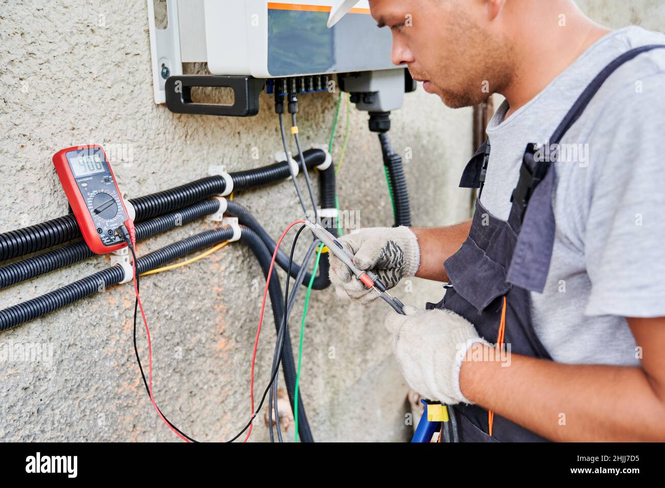 Man electrician installing solar panel system. Close up technician in ...
