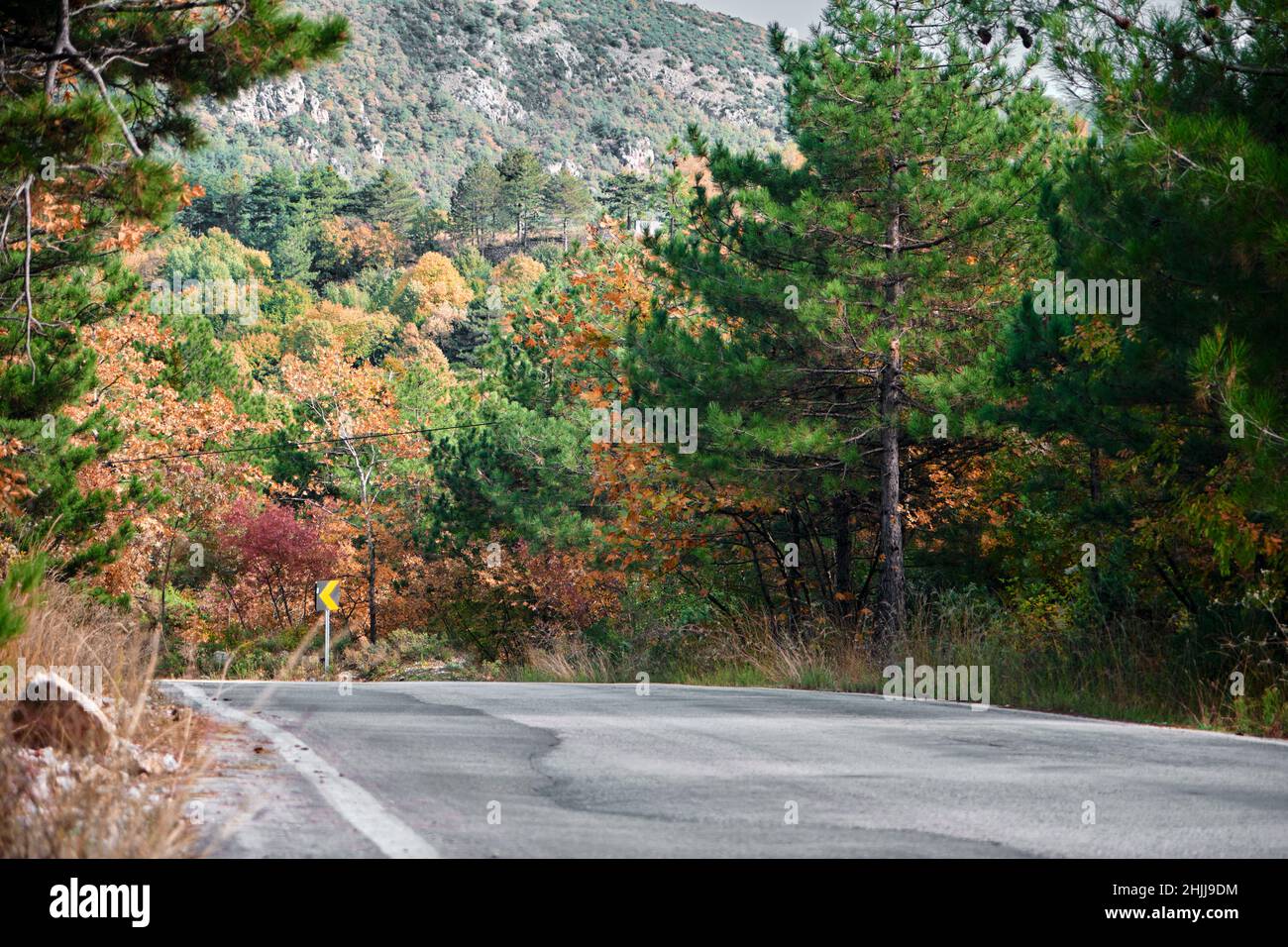 Asphalt road, low and wide angle photo of road with turning sign with ...