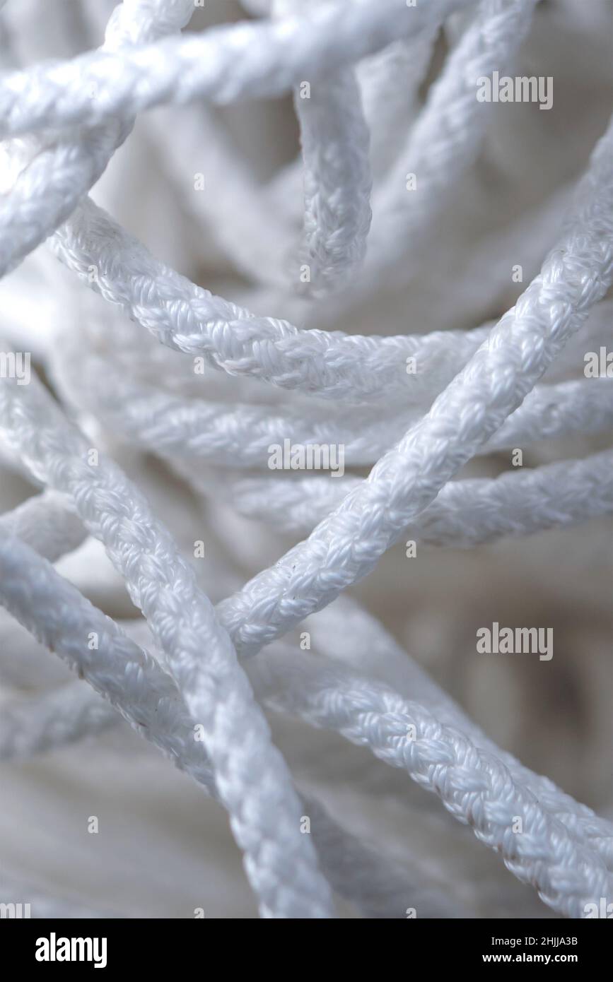 Thick tangled white rope close up. Close-up of an worn out boat rope as ...