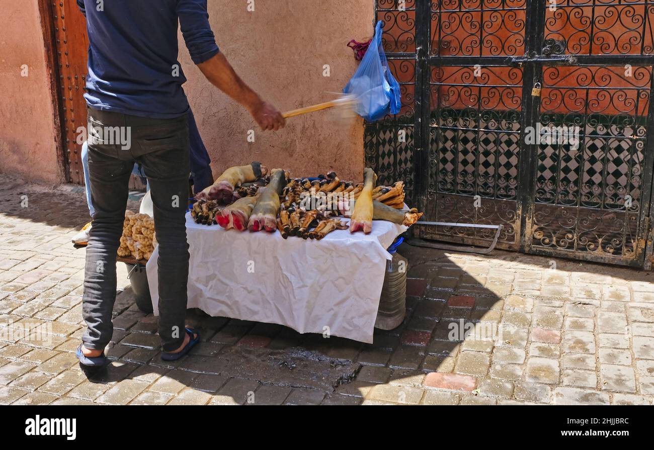 Man selling hoof meat at the street market in Marrakech Stock Photo - Alamy