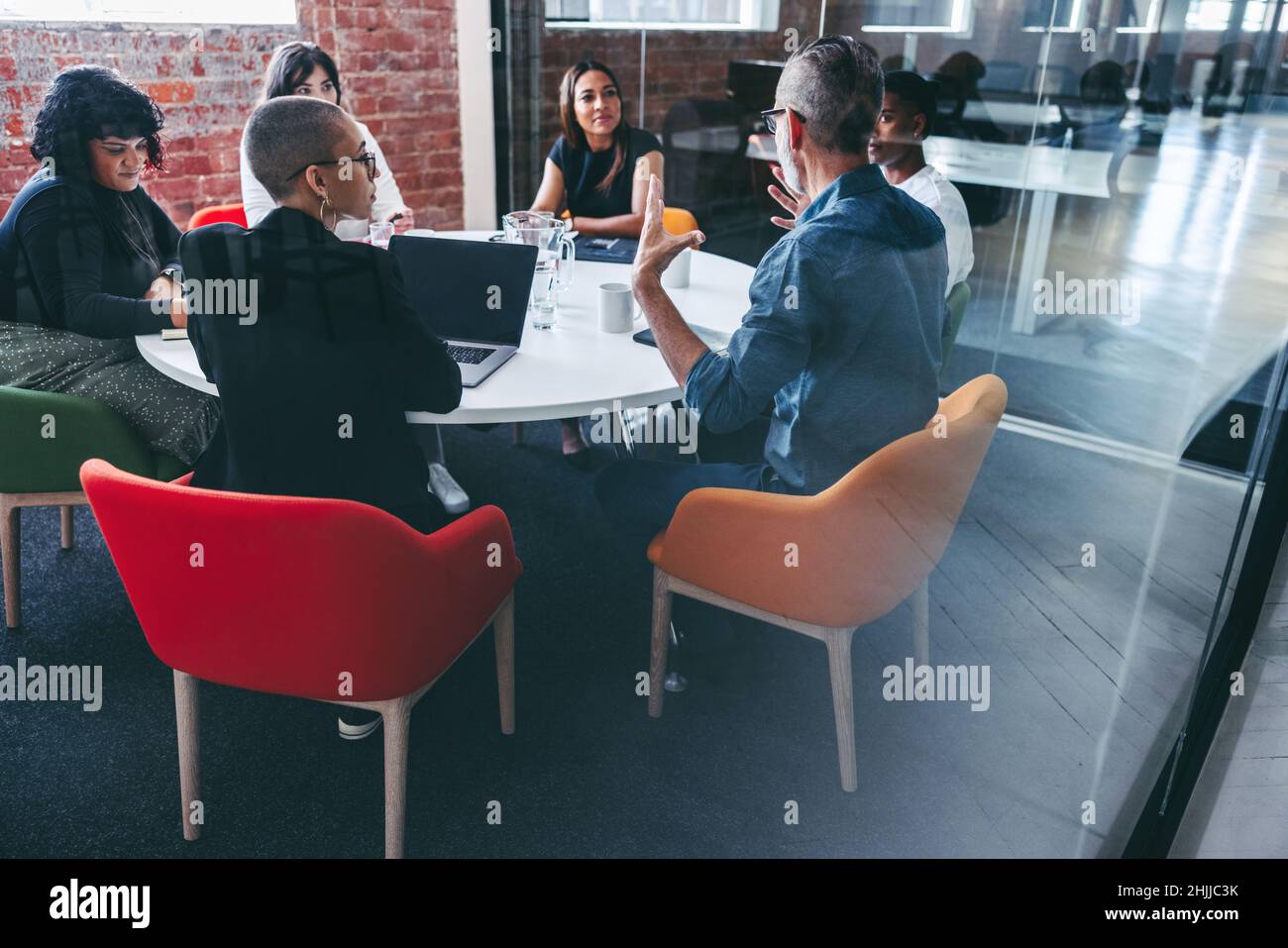 Male supervisor briefing his team in the morning. Experienced mature ...