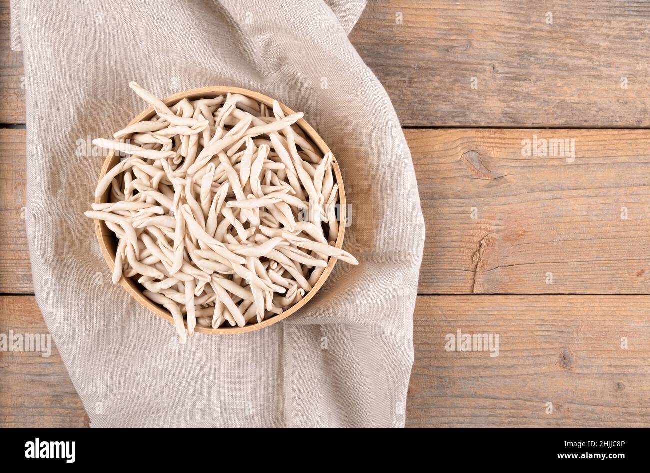 Whole grain wheat apulian pasta Pizzarieddi or maccaruni in a sieve on ...