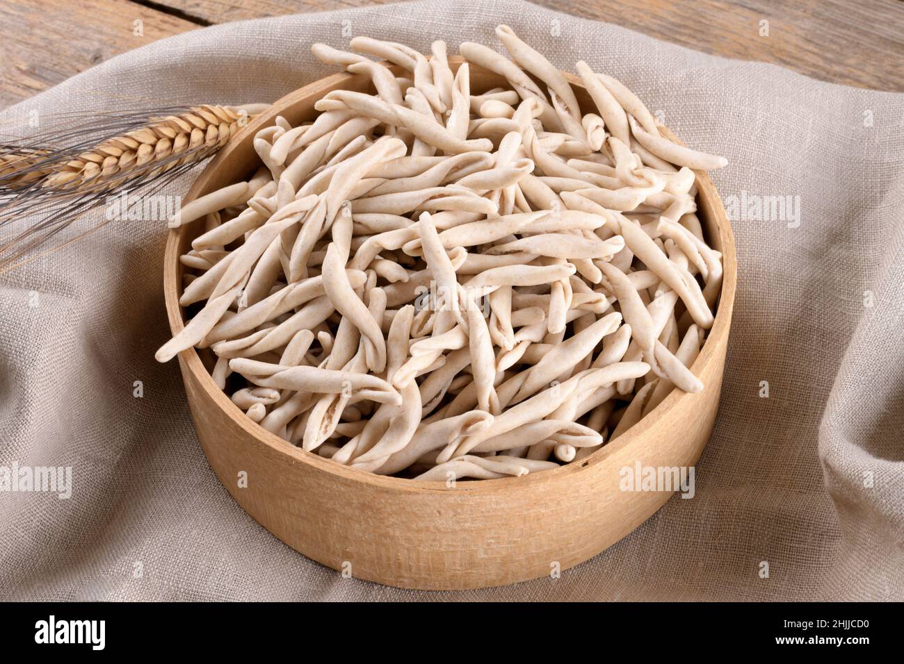 Whole grain wheat apulian pasta Pizzarieddi or maccaruni in a sieve on ...