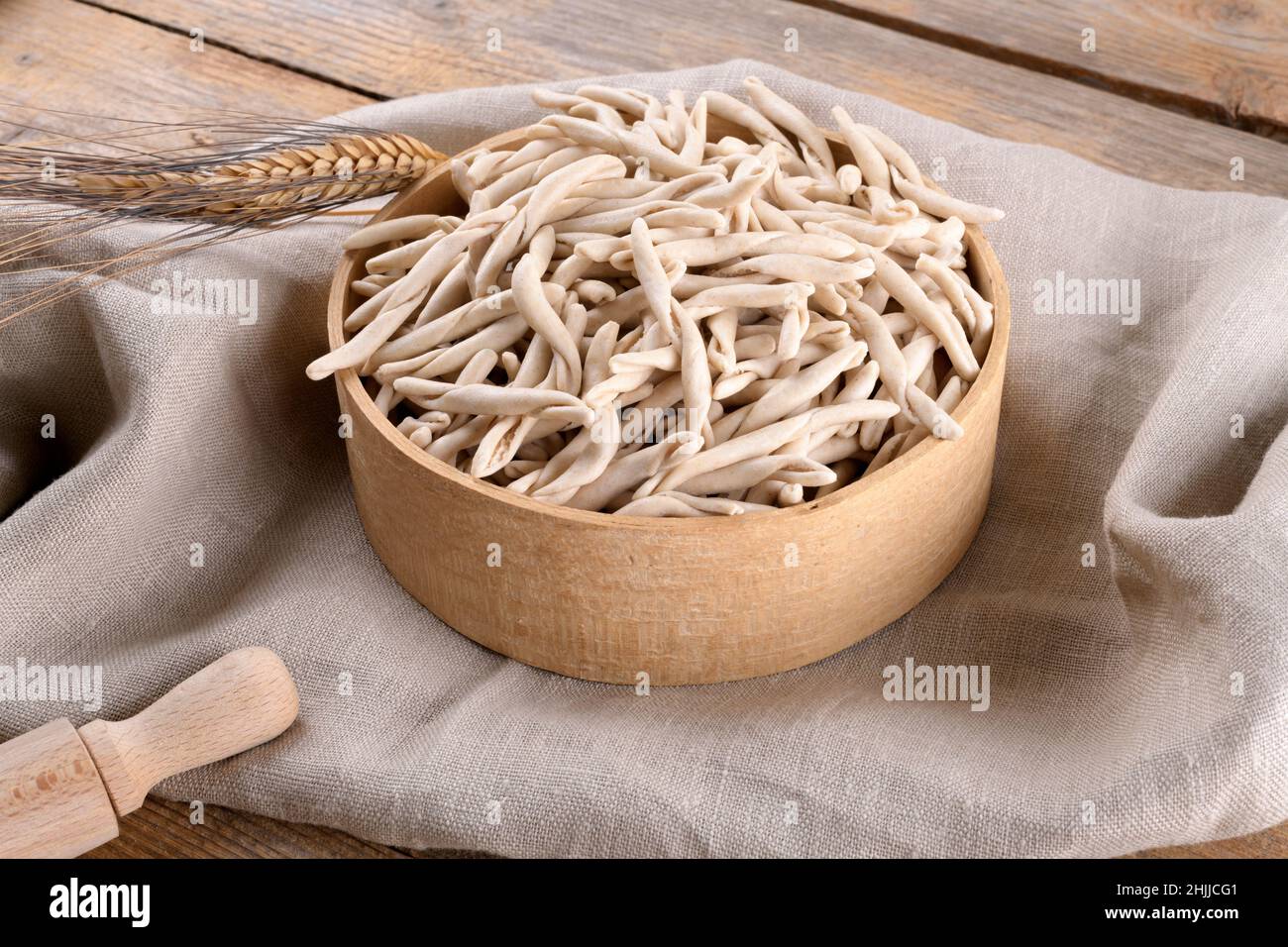 Whole grain wheat apulian pasta Pizzarieddi or maccaruni in a sieve on ...