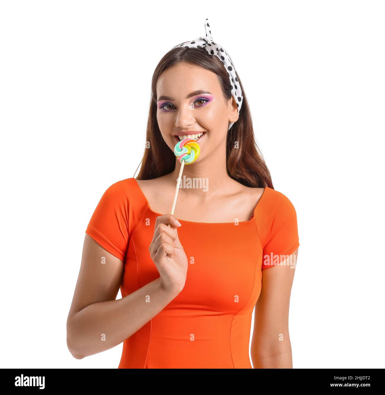 Pretty young woman eating lollipop on white background Stock Photo - Alamy
