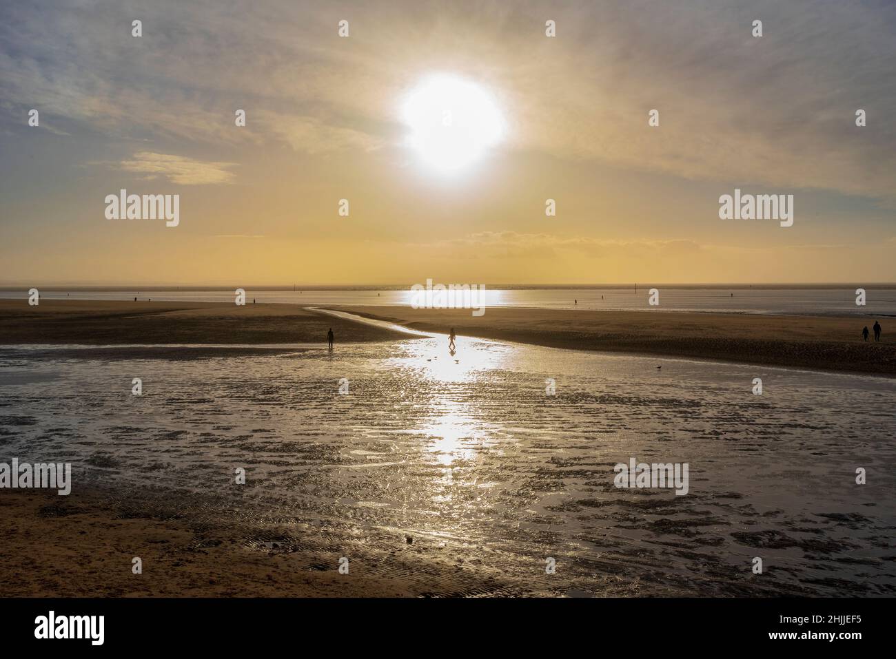 Crosby beach on the river Mersey at sunset ona winters afternoon with ...