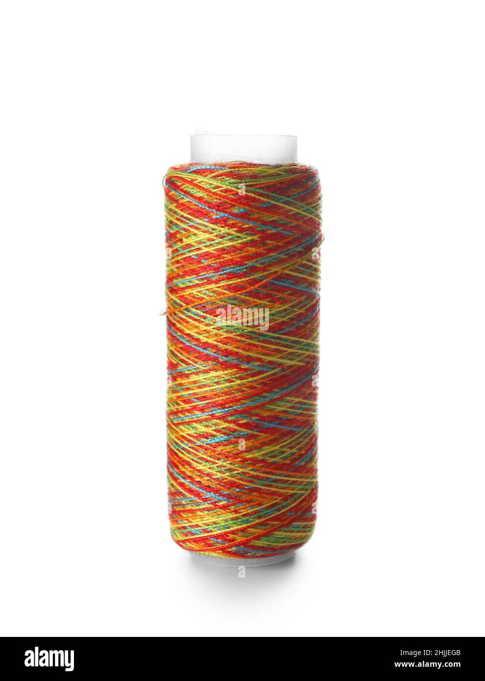 Rainbow sewing thread spool on white background Stock Photo - Alamy