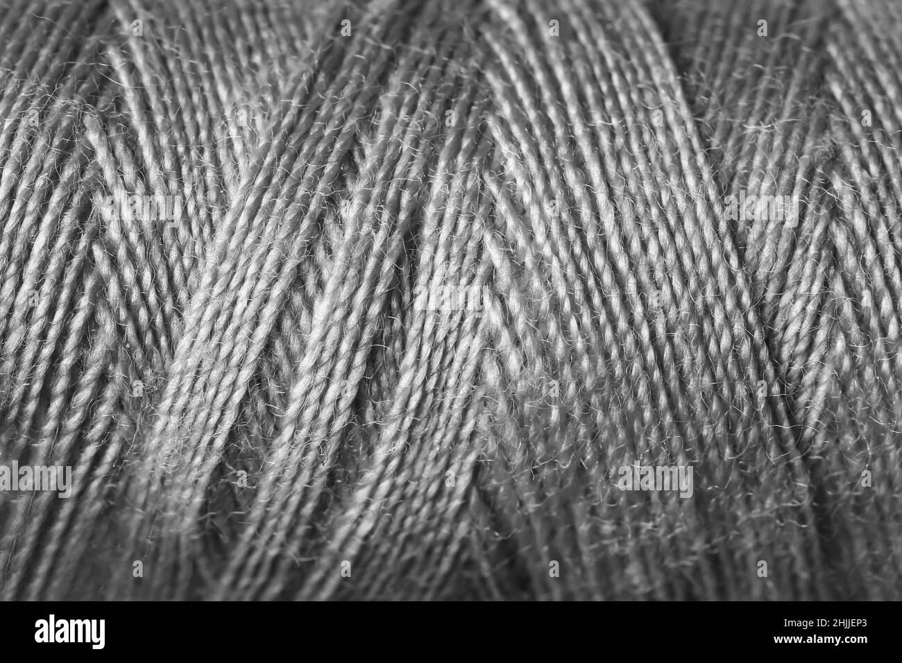 Grey sewing threads as background Stock Photo - Alamy