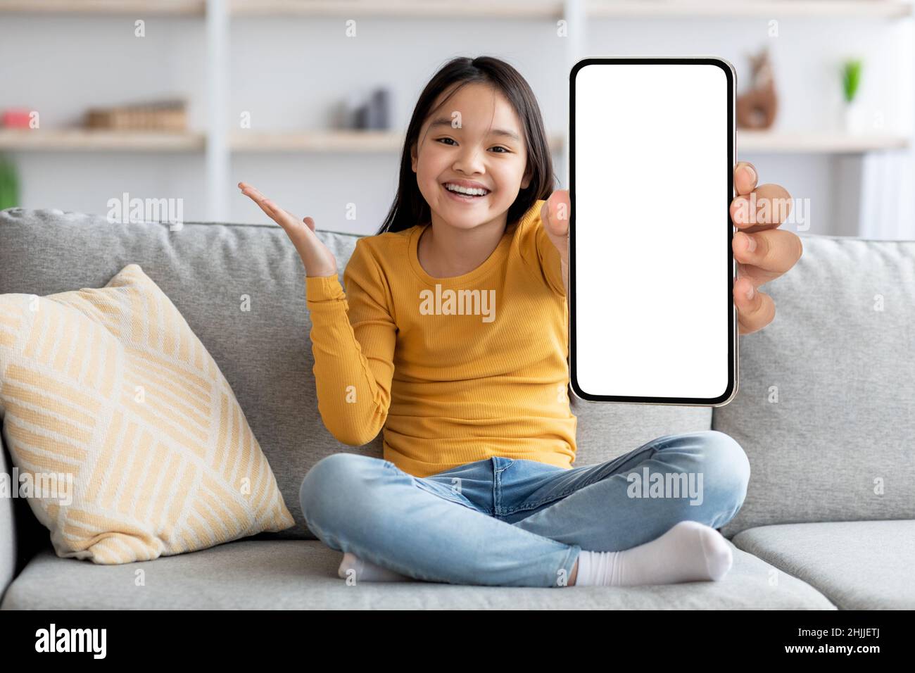 Cute pretty korean girl showing smartphone with empty screen Stock ...