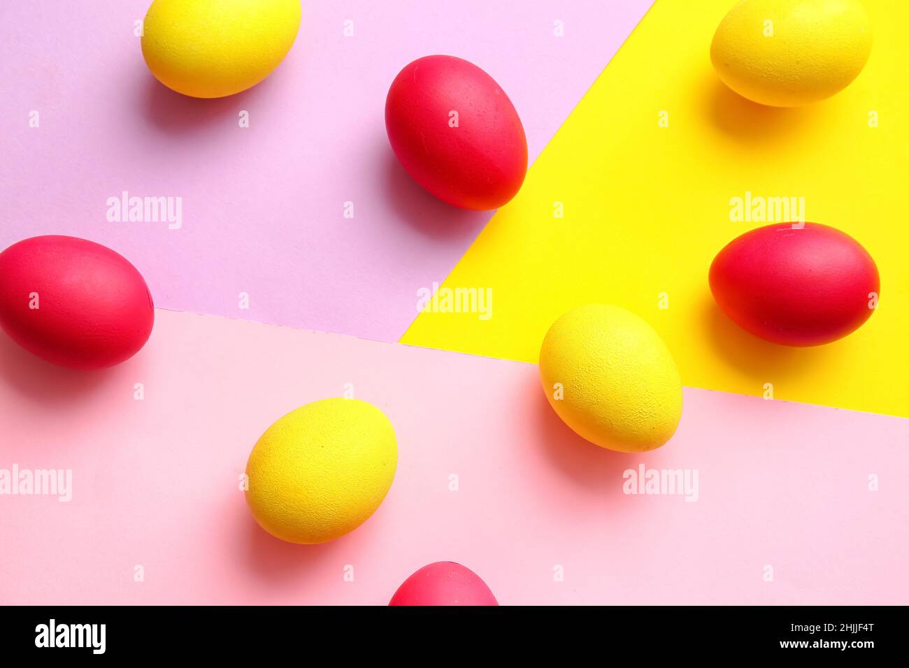 Red and yellow Easter eggs on color background Stock Photo - Alamy
