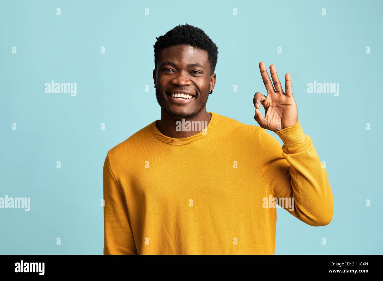 Cheerful african american guy showing okay gesture Stock Photo - Alamy