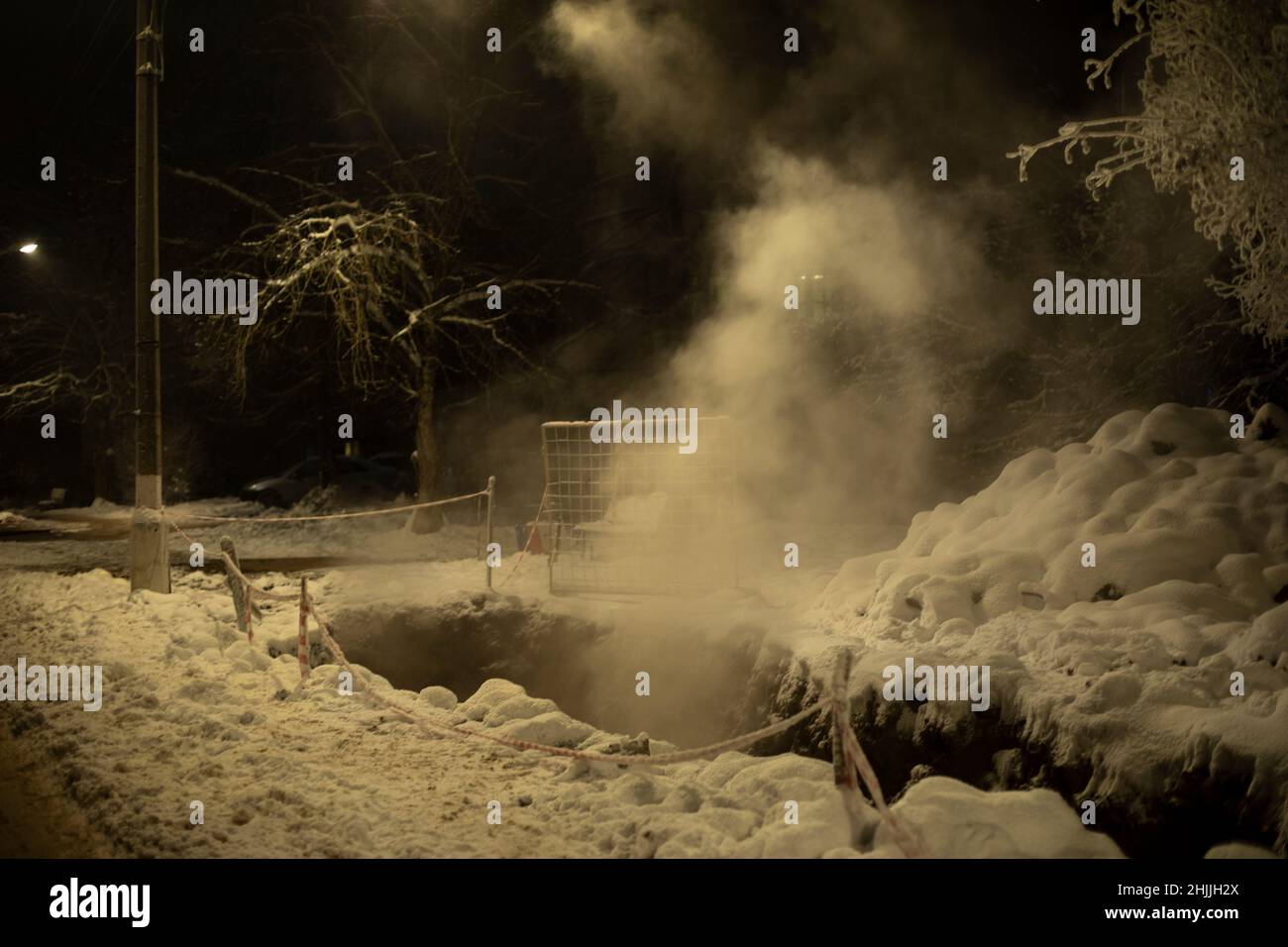 Sewer is excavated at night. Steam from pipe break over pit. Accident ...