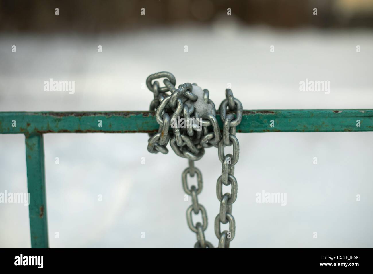 Steel chain is wound on handrail. Chain to protect bike. Links are ...