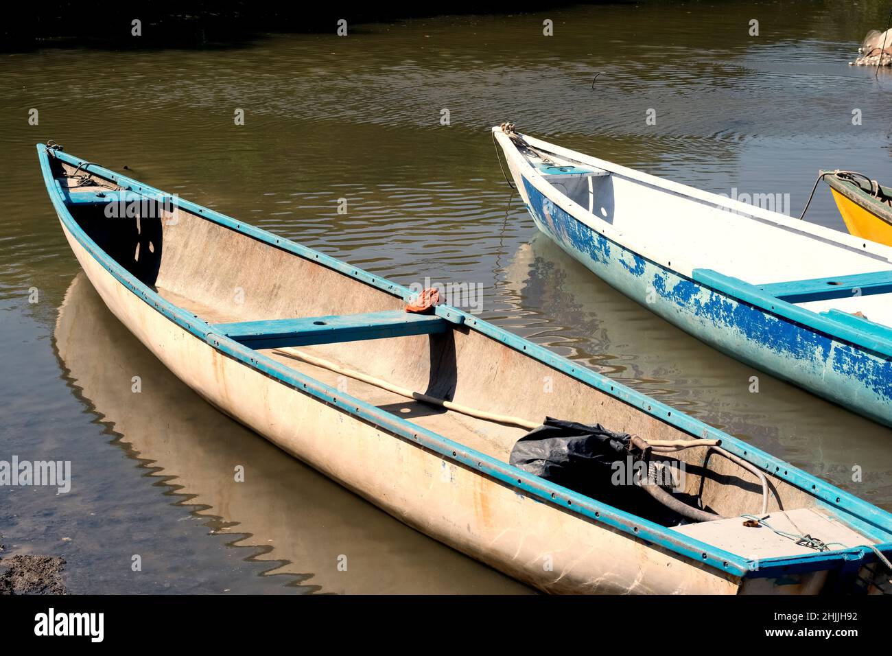 Canoes and colorful boats docked on the Paraguacu River in Saubara in ...