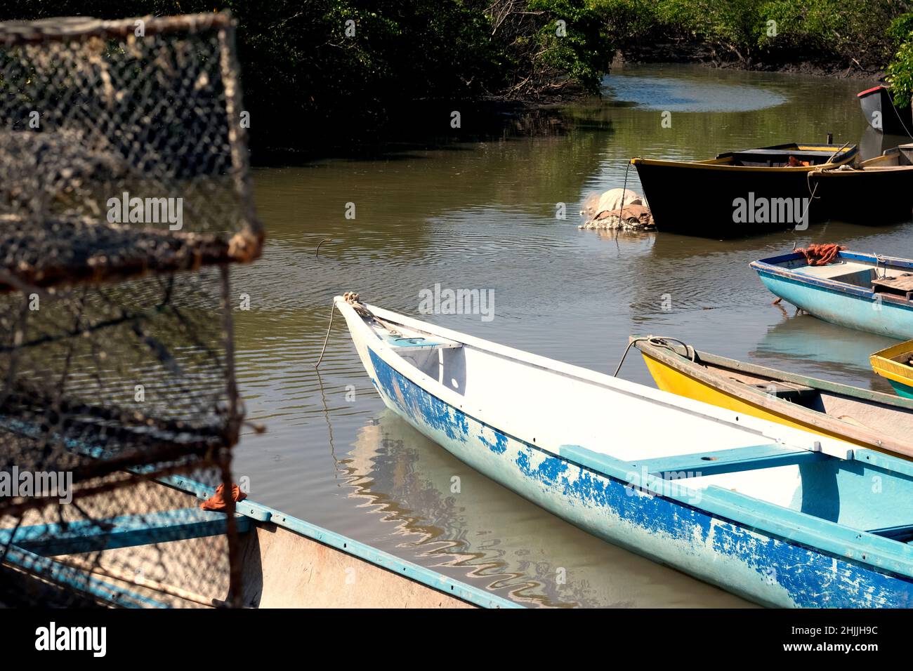 Canoes and colorful boats docked on the Paraguacu River in Saubara in ...
