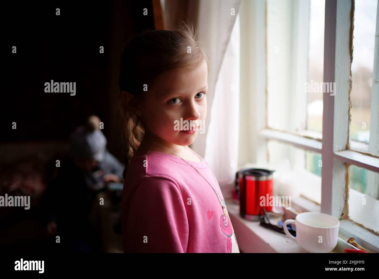 Girl near the window Stock Photo - Alamy