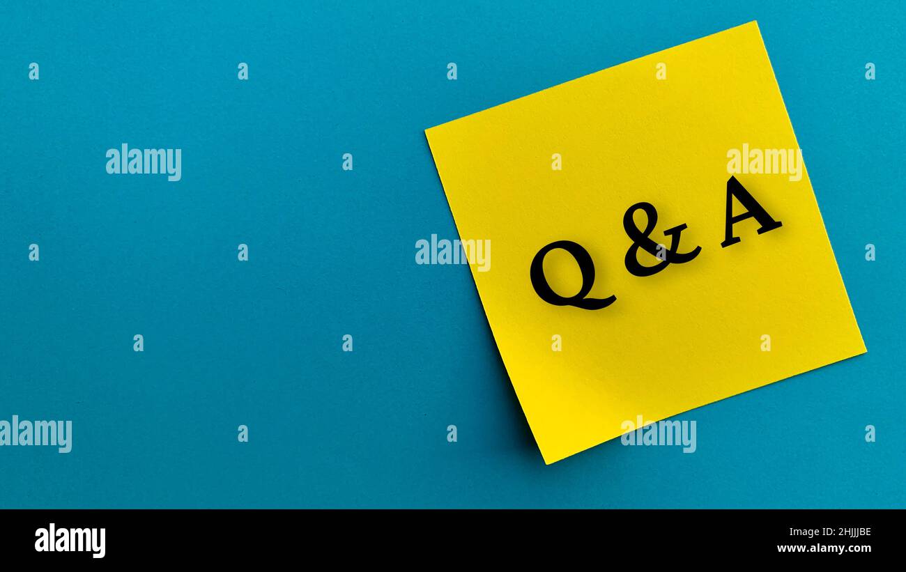 Top view of text - Question and Answer sticky note with blue background ...