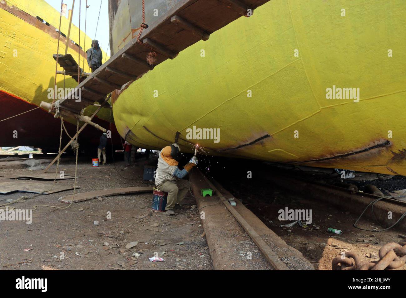 Dockyard laborers seen around the ships along the bank of the Buriganga ...