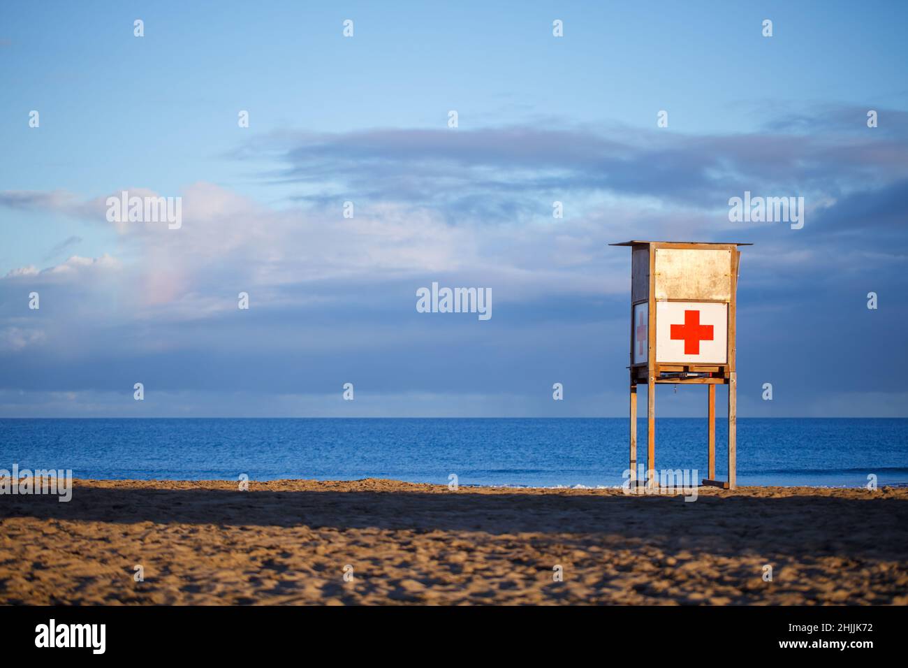 lifeguard booth with a red cross on Sandy Beach Stock Photo - Alamy