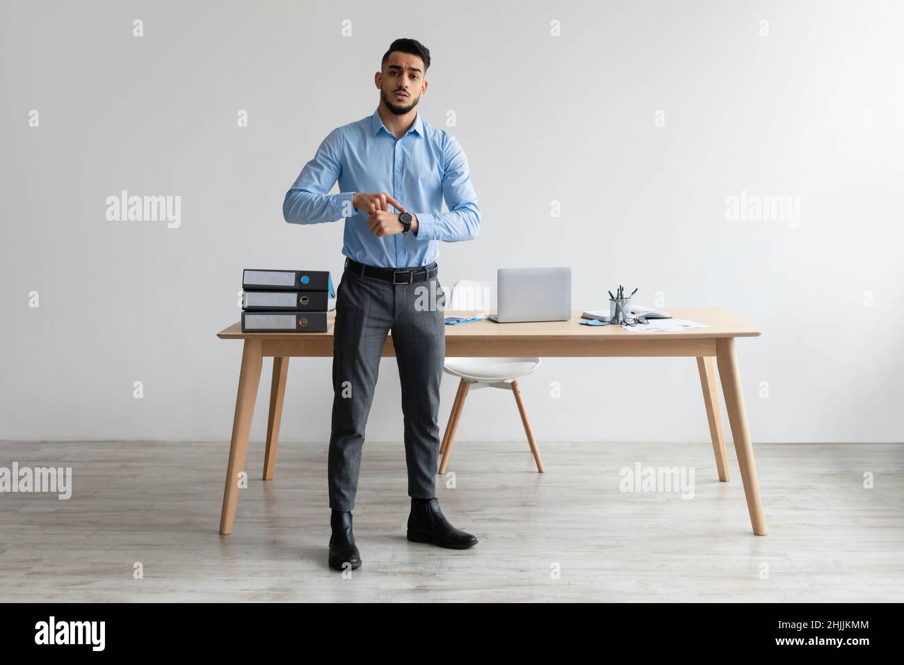 Serious Middle Eastern Male Manager Pointing Finger At Wrist Watch ...