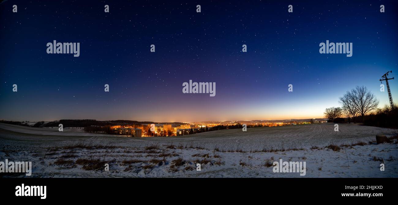 Panorama of the starry night sky with the light of the city on the ...