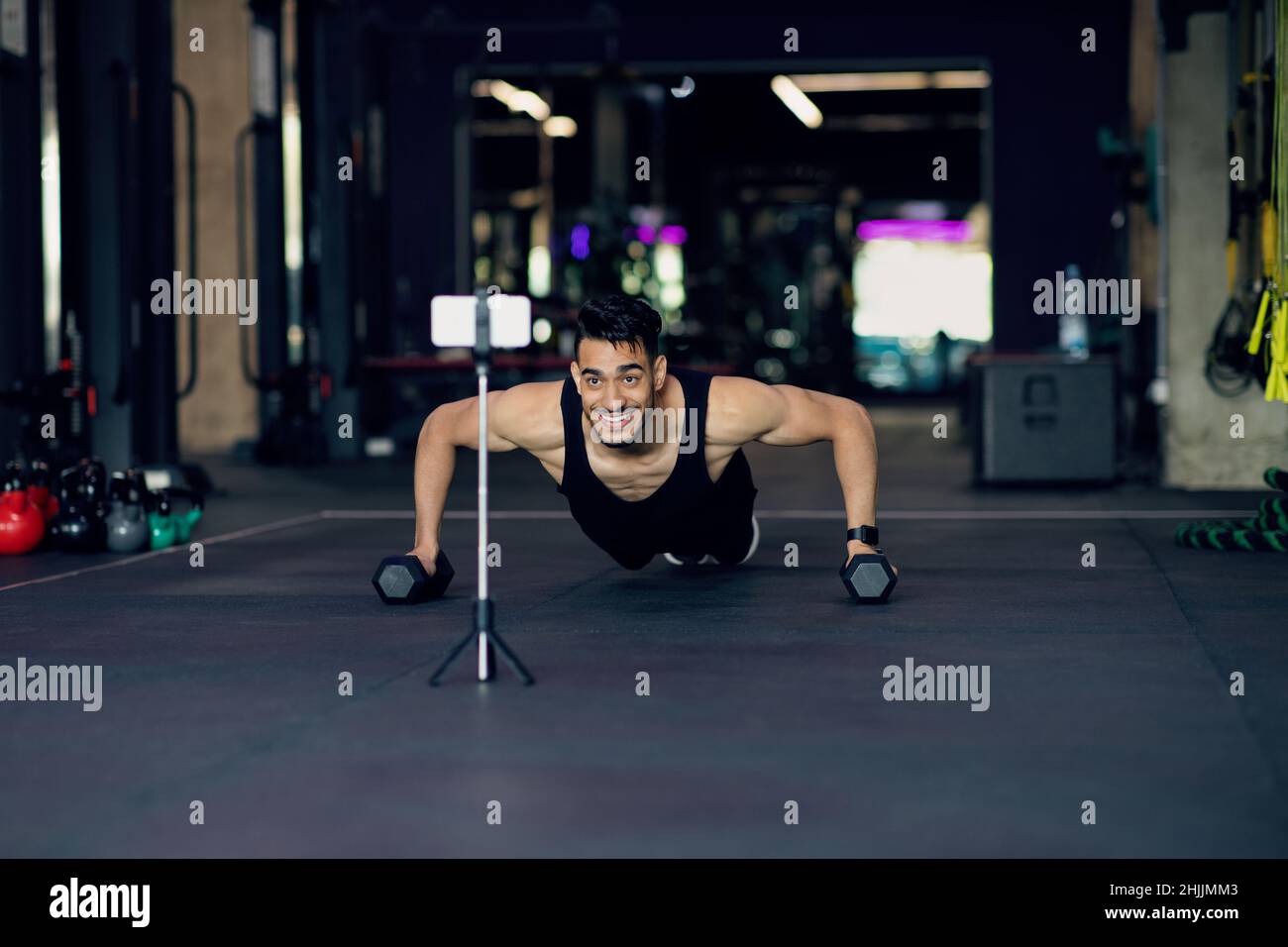 Athletic Arab Man Making Dumbbell Push-Ups While Recording Content On ...