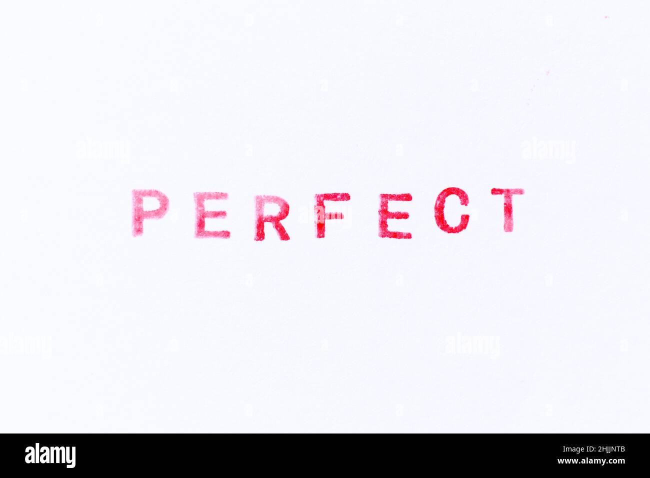 Red color ink rubber stamp in word perfect on white paper background ...