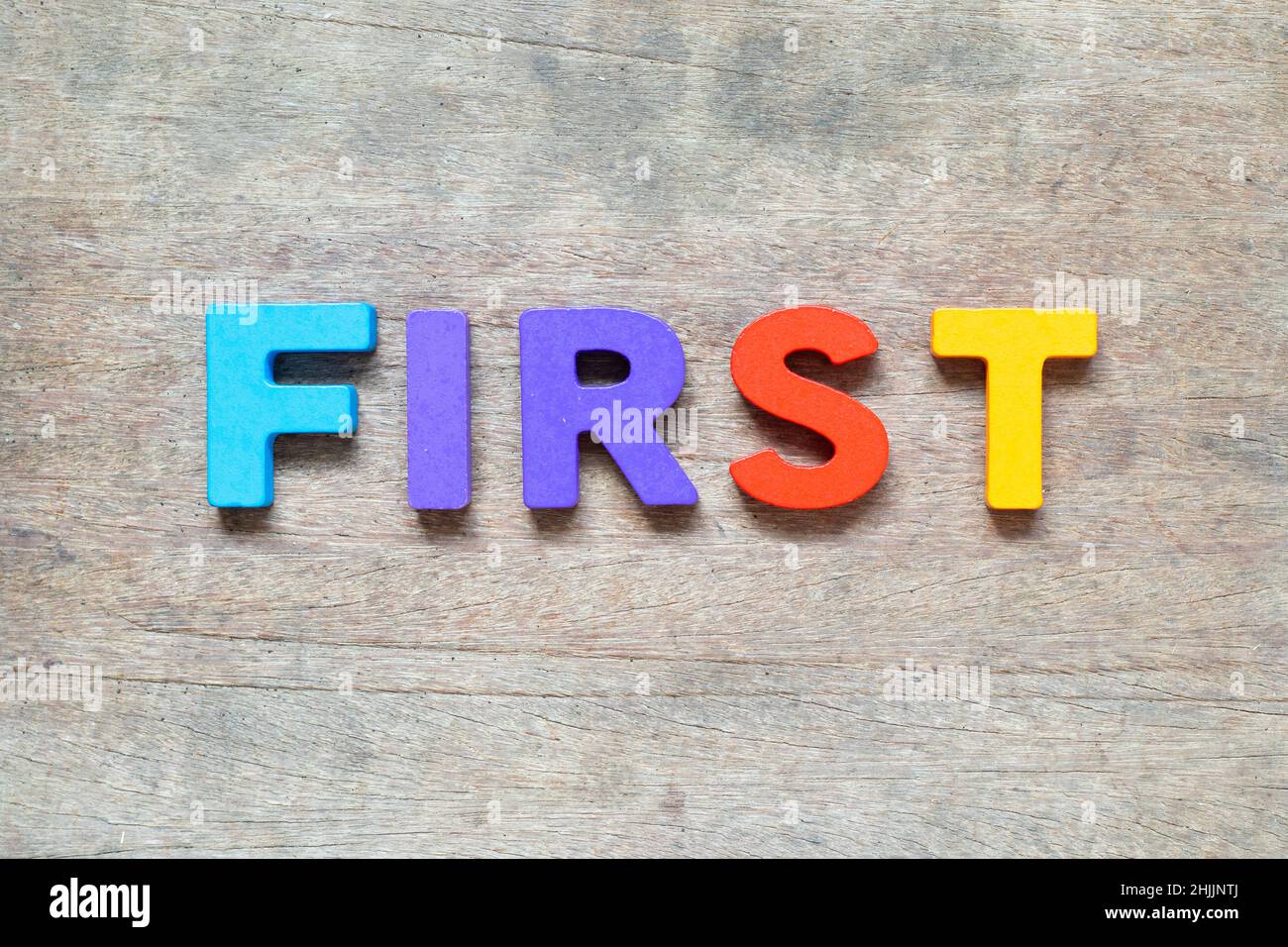 Color alphabet letter with word first on wood background Stock Photo ...