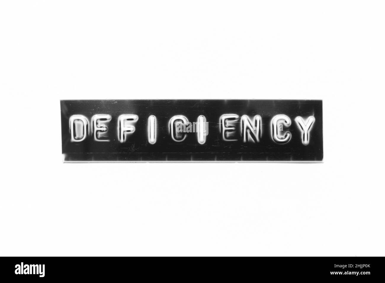Embossed letter with word deficiency in black banner on white paper ...