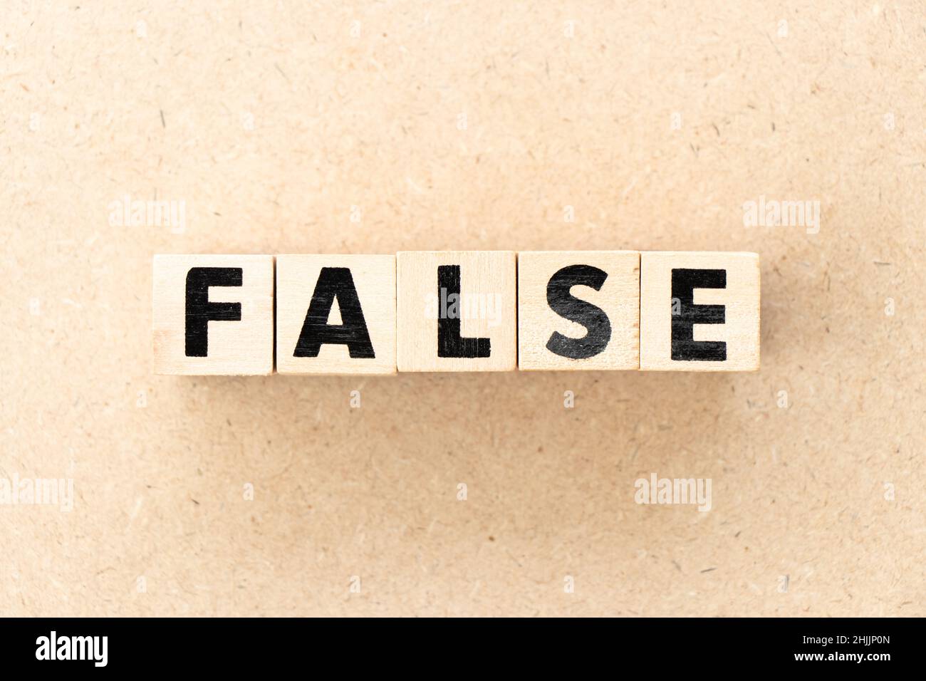 Alphabet letter block in word false on wood background Stock Photo - Alamy
