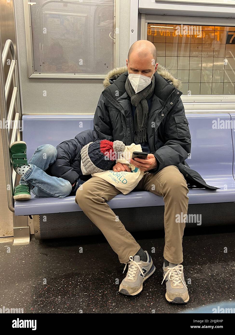 Man with his son fully masked riding a subway train in New York City ...