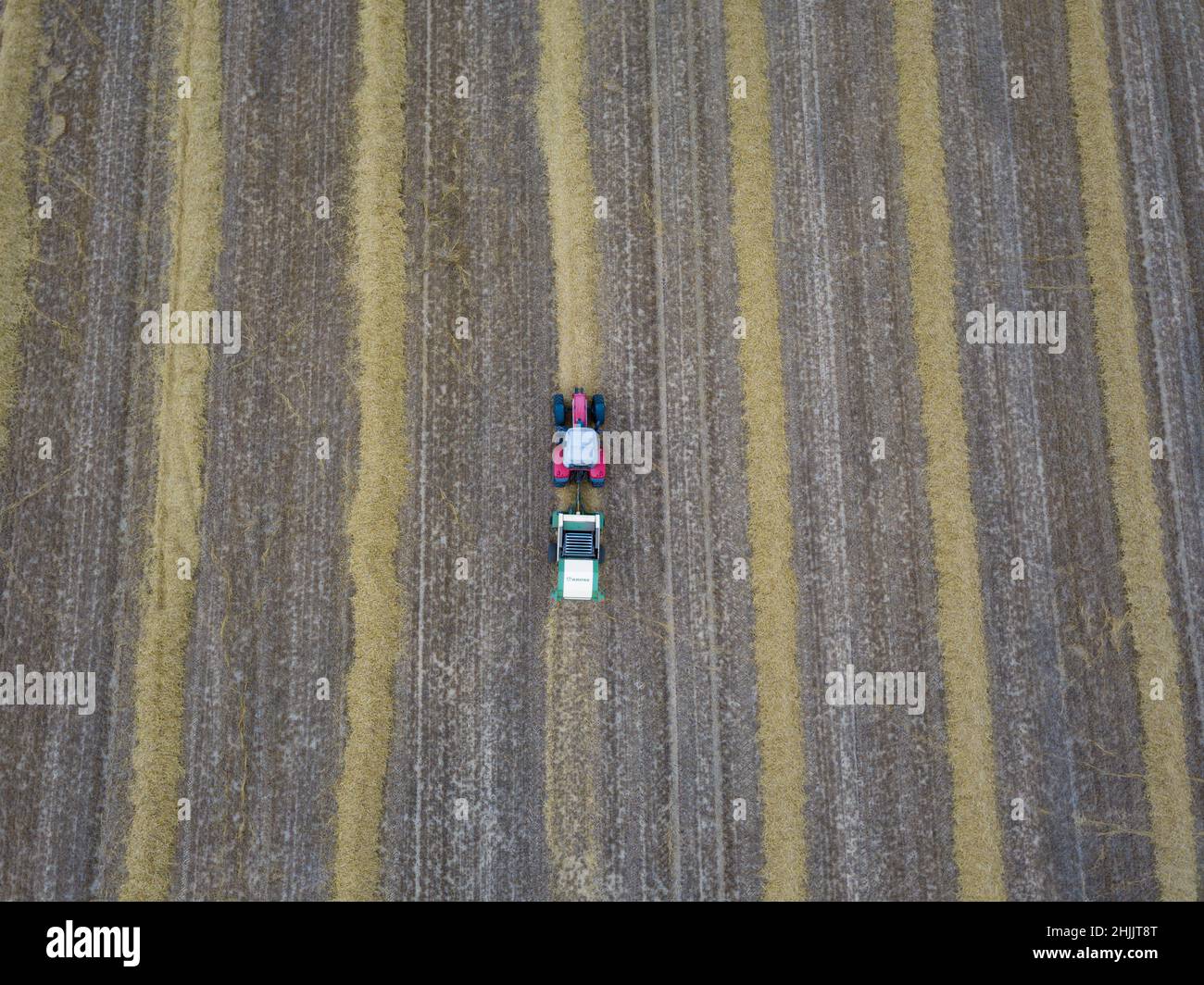 Woodbridge Suffolk UK 24 July 2021: Aerial shot of a tractor using a ...