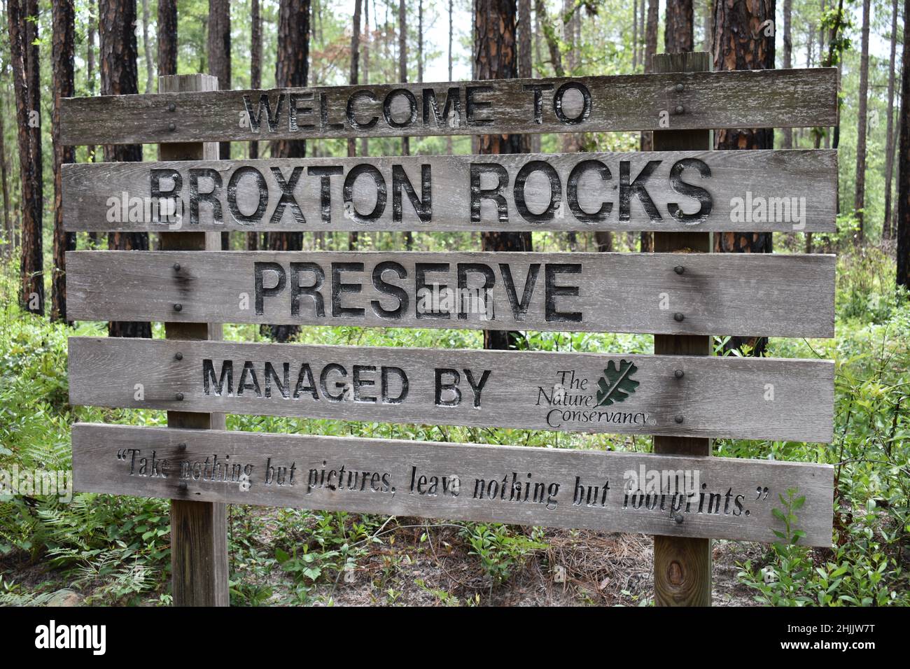 Wooden signboard with welcome greetings to the Broxton Rocks Preserve ...