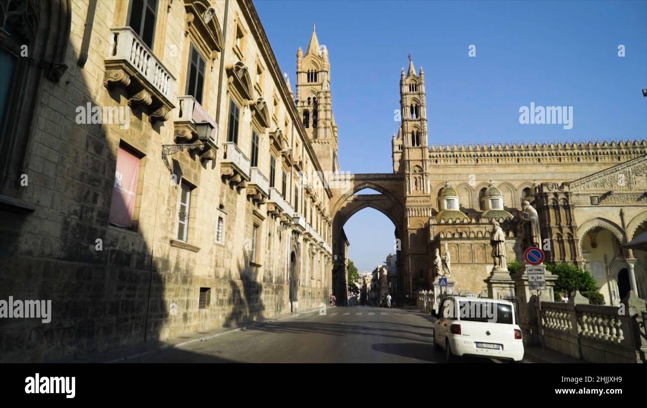 Beautiful arched passage with towers of old architectural building on ...