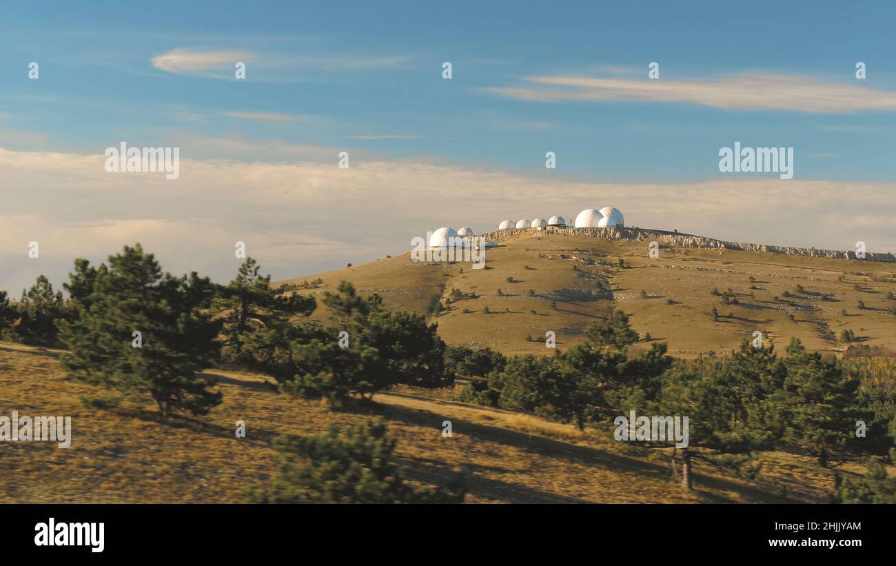 Top view of white domed buildings of observatories on hill. Shot ...