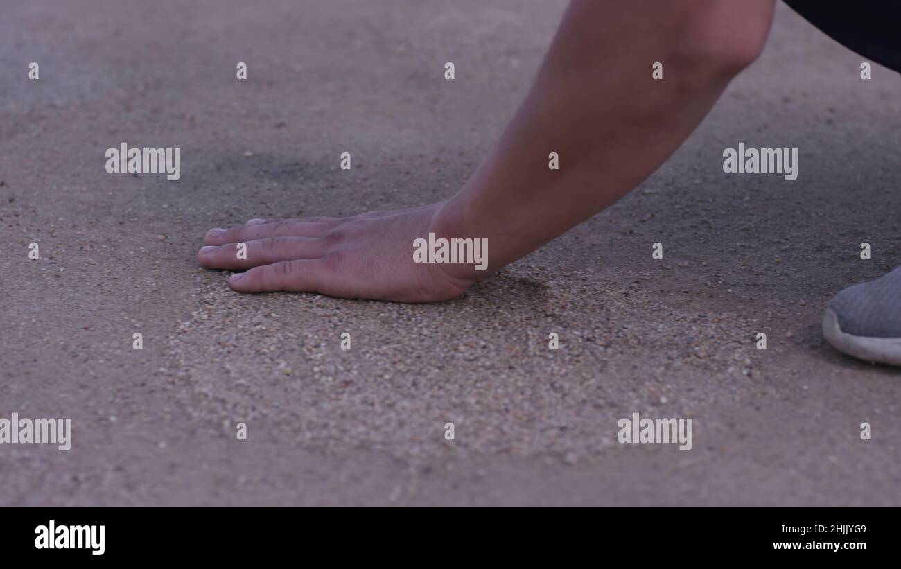 Man's hand touches to their native land. Young man finally home ...