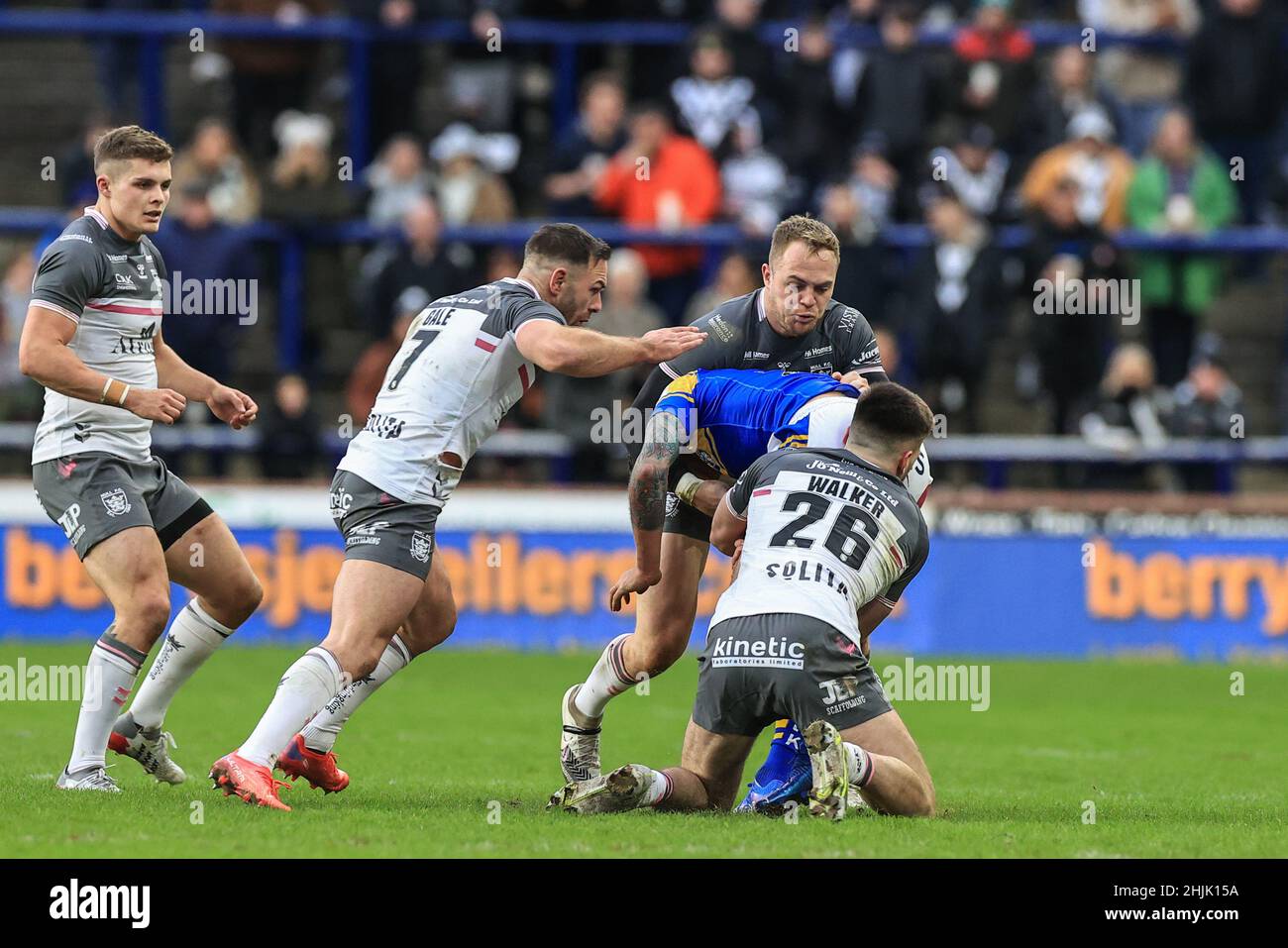 Tom Briscoe of Leeds Rhinos is tackled by Adam Swift of Hull FC and ...