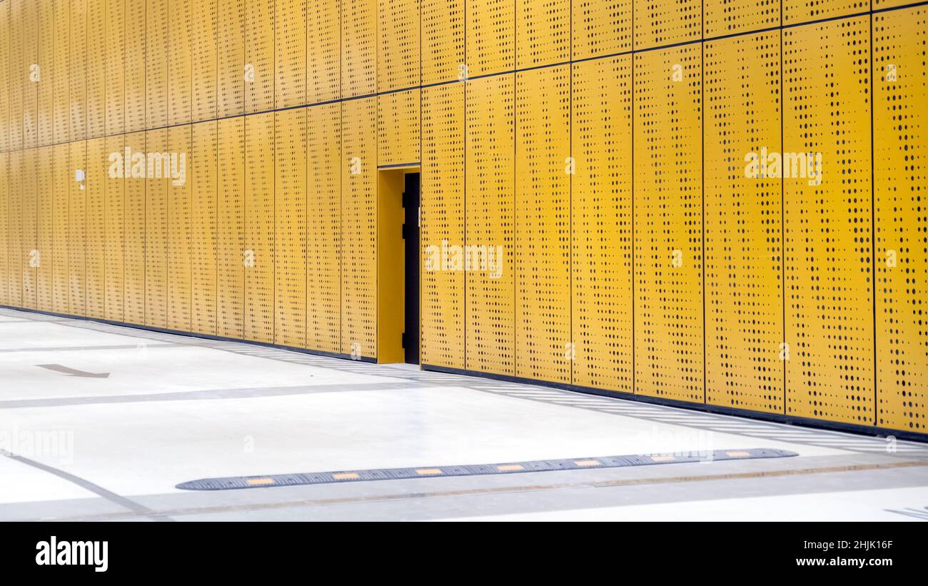 Perforated metal wall background, front view. Yellow metal background ...