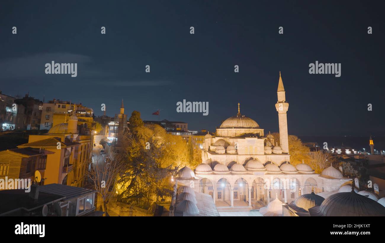 Beautiful mosque on background of night city. Action. Illuminated by ...