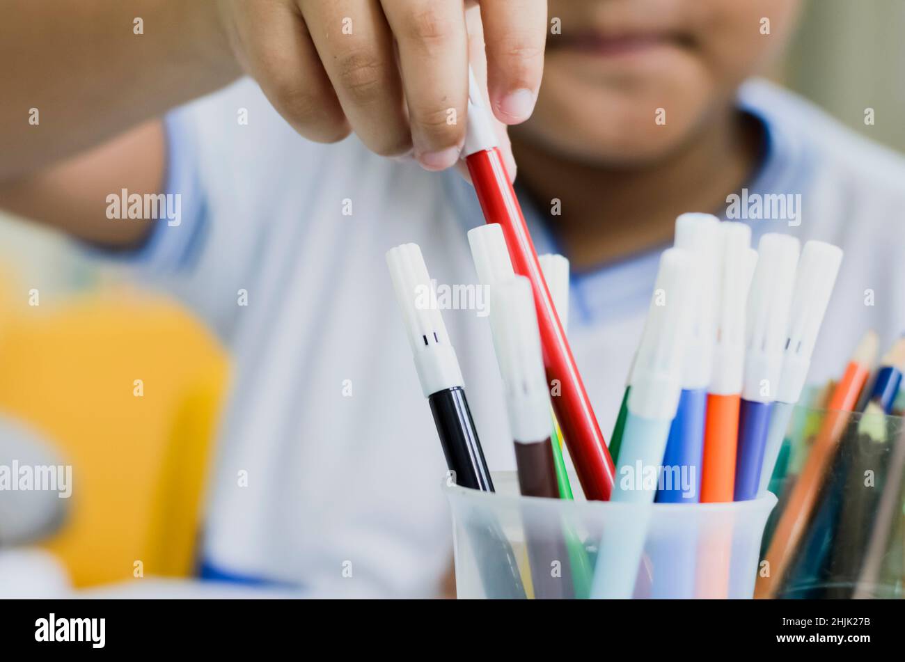 Savador, Bahia, Brazil - December 16, 2014: Hands picking up crayons to ...