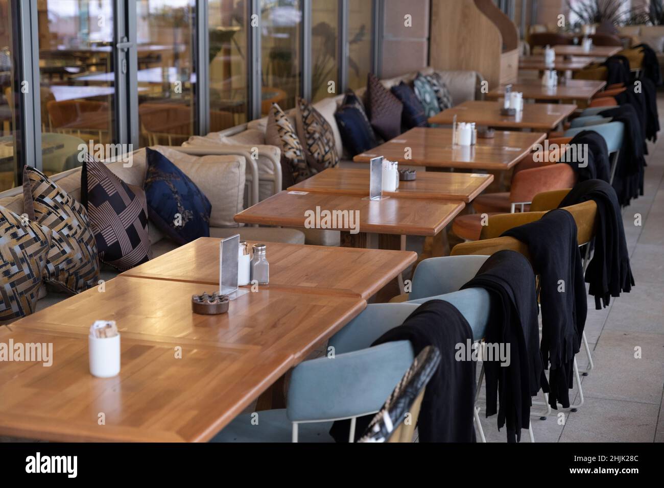 The interior of the restaurant. Empty dining tables background standing ...