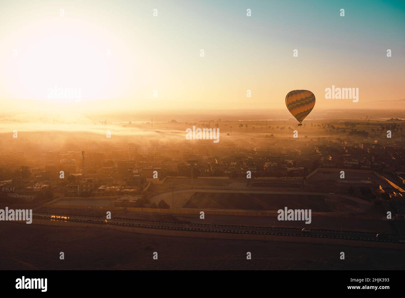 One single hot air balloon in the air, flying low height above the ...